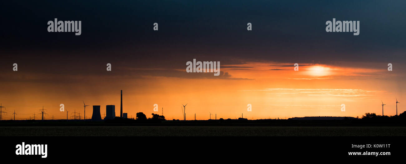 The rising sun floods the sky with a warm light while a storm front ...