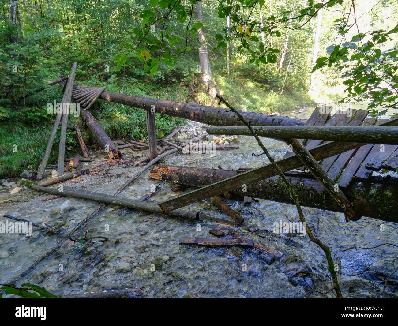A collapsed pedestrian bridge lying on the Weissbach river near ...