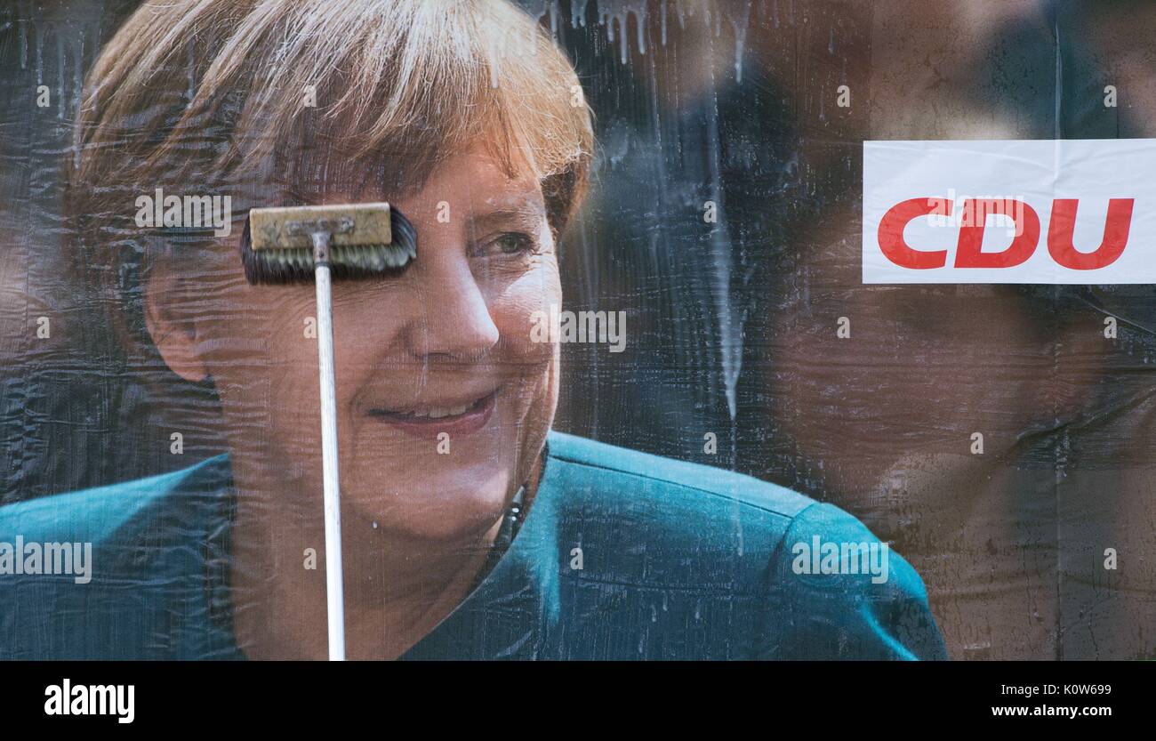 Dresden, Germany. 25th Aug, 2017. A man pasting on a wall a Bundestag ...