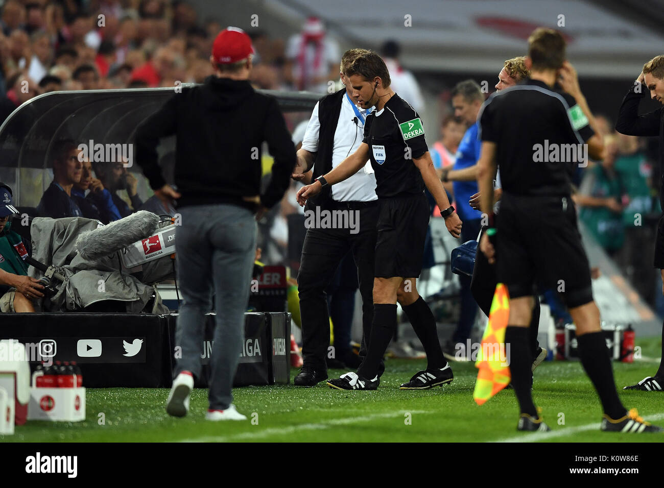 Referee Felix Brych leaves the pitch injured during the German ...