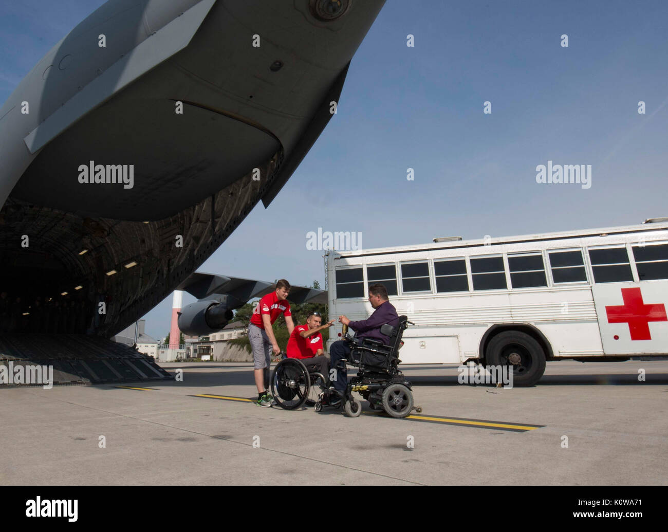 From left to right, former Canadian Army Major Simon Mailloux, helps ...