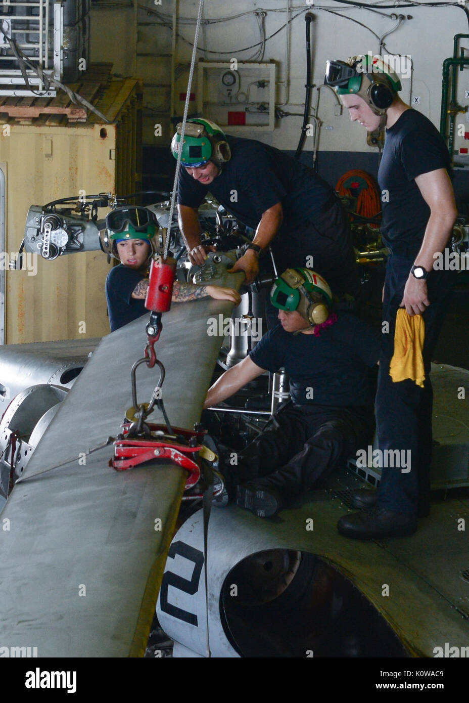 U.S. Navy Sailors installed a blade on an MH-60R Sea Hawk helicopter ...