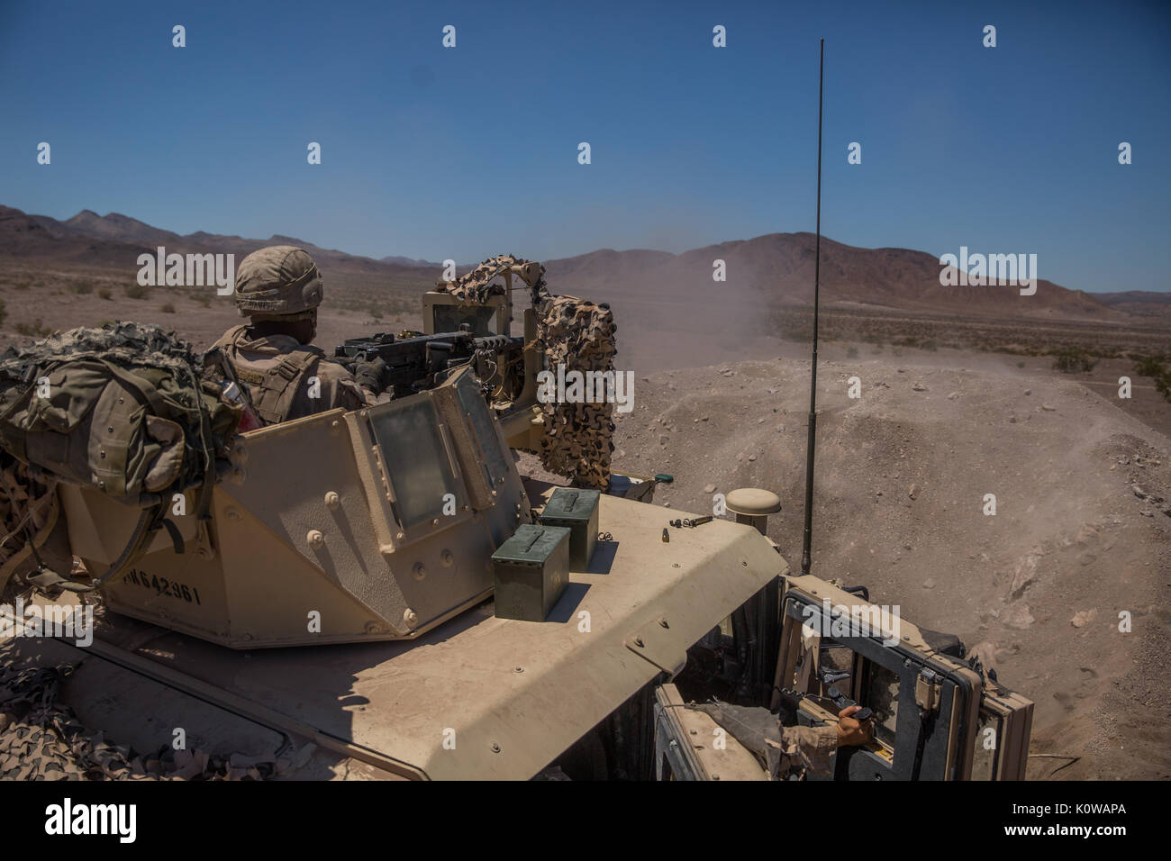 A Marine fires a M2 .50 caliber machine gun at simulated enemy ...