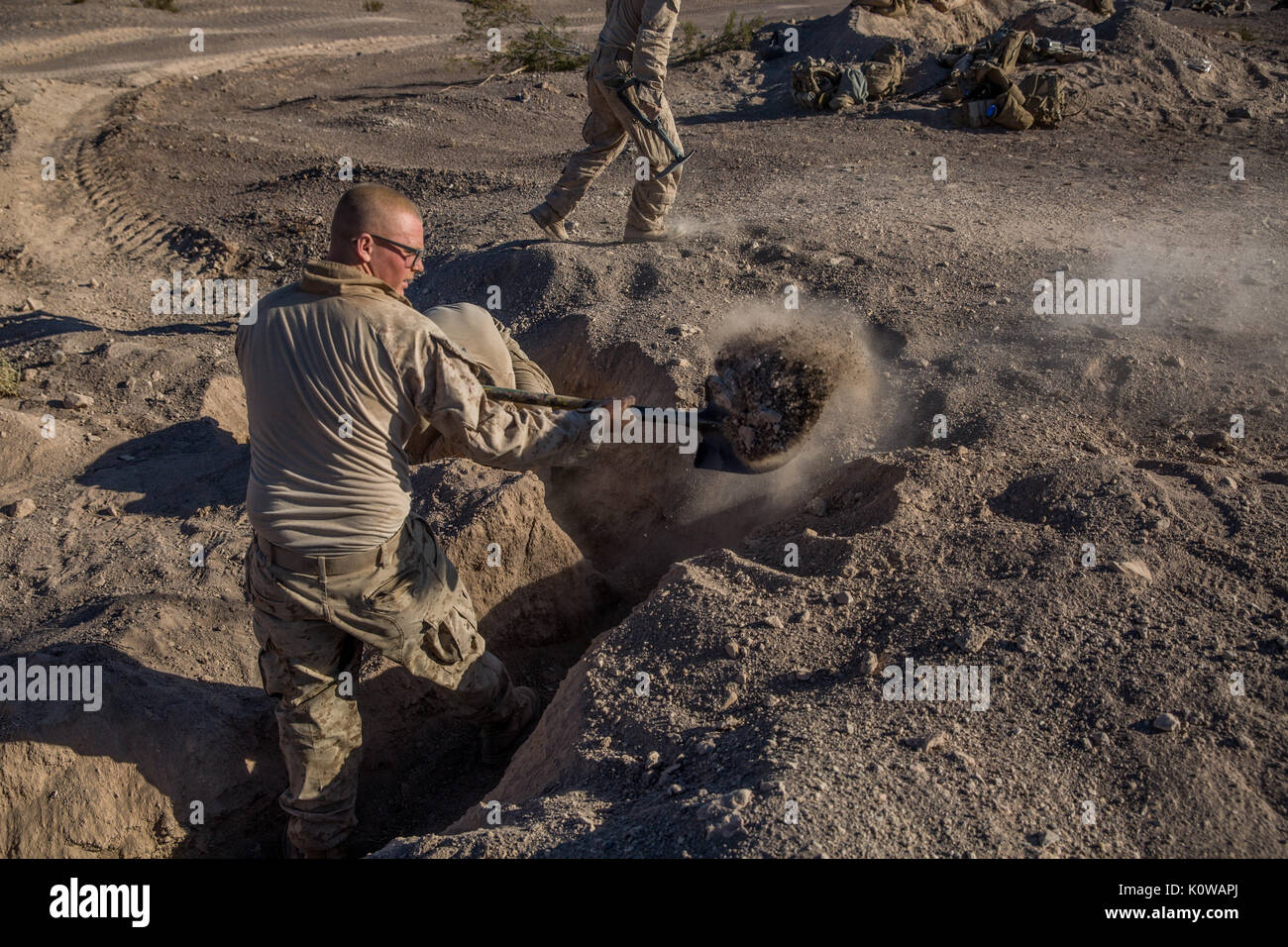 A Marine fortifies a machine gun position for a battalion defense ...