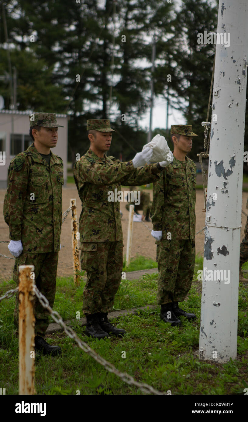 Japanese Ground Self Defense Force soldiers prepare to raise the ...