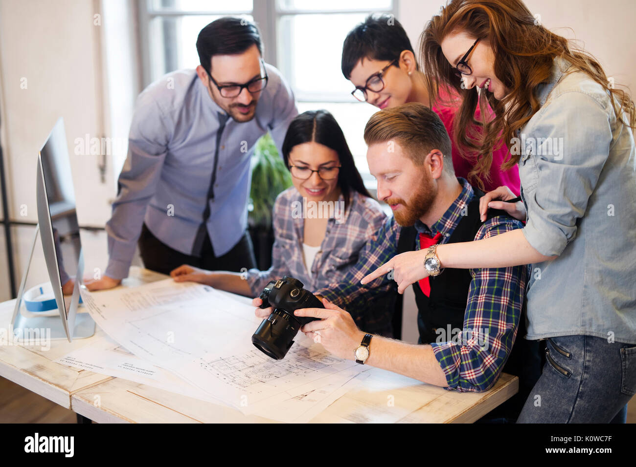 Group of young perspective designers working with camera Stock Photo ...