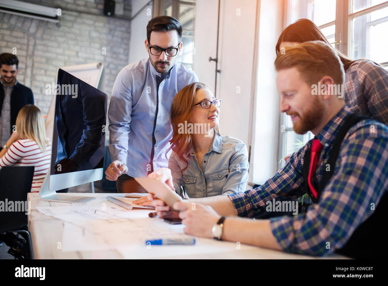 Group of young architects using digital tablet Stock Photo - Alamy