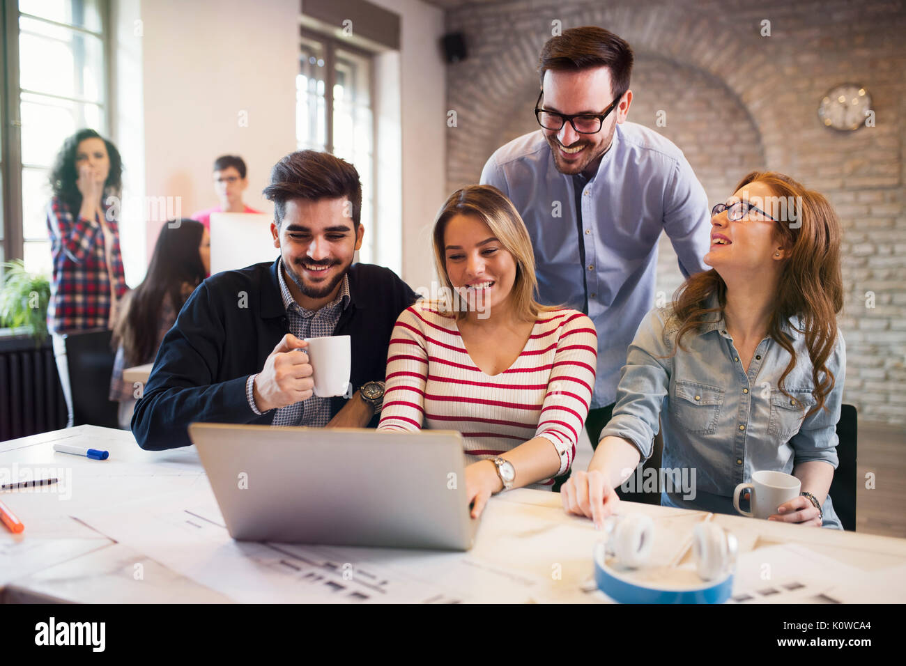 Group of young architects working on laptop Stock Photo - Alamy