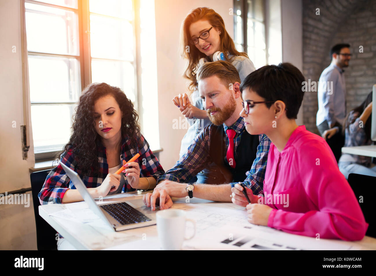 Group of young architects working on laptop Stock Photo - Alamy