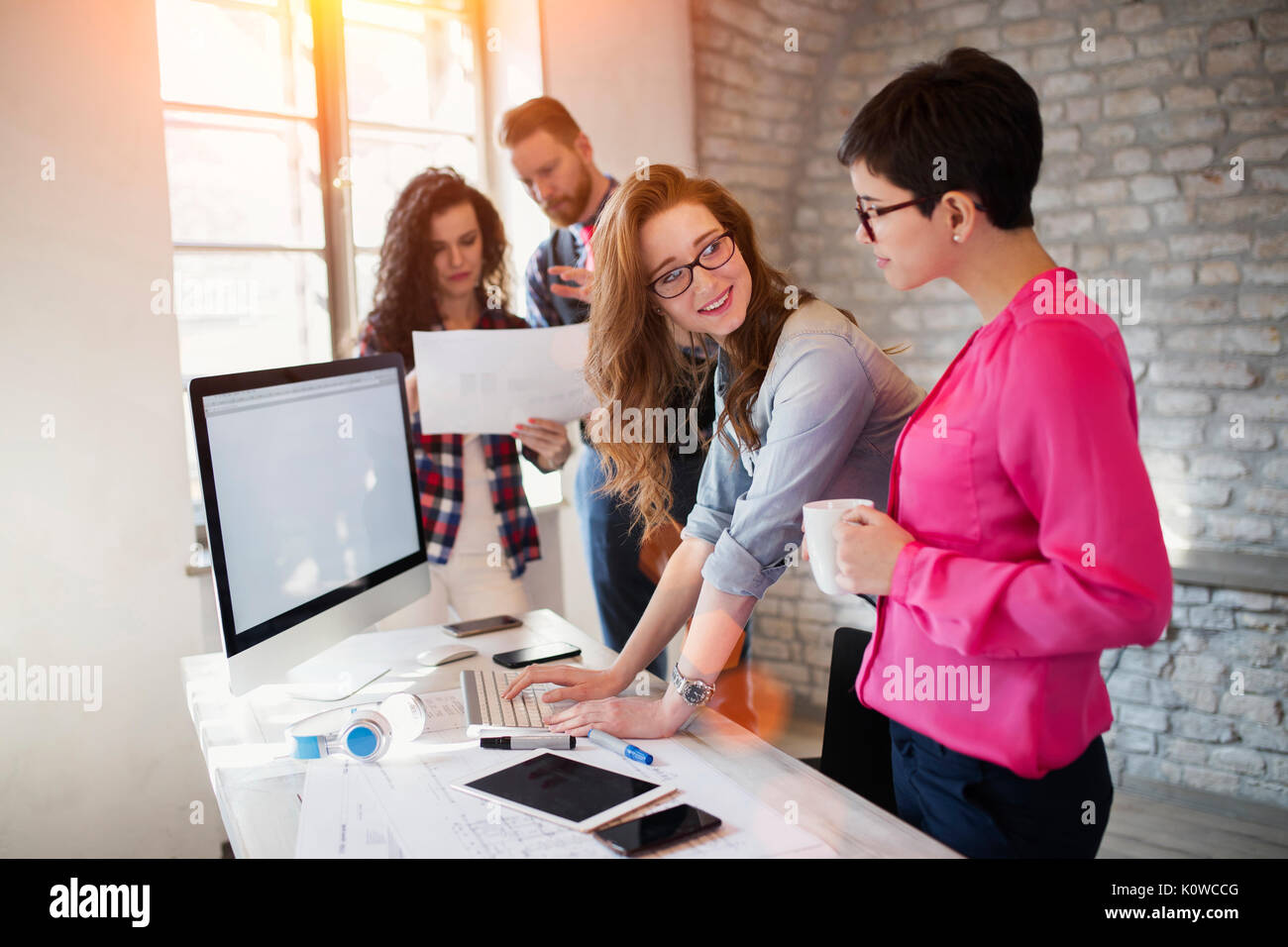 Group of young architects working on computer Stock Photo - Alamy
