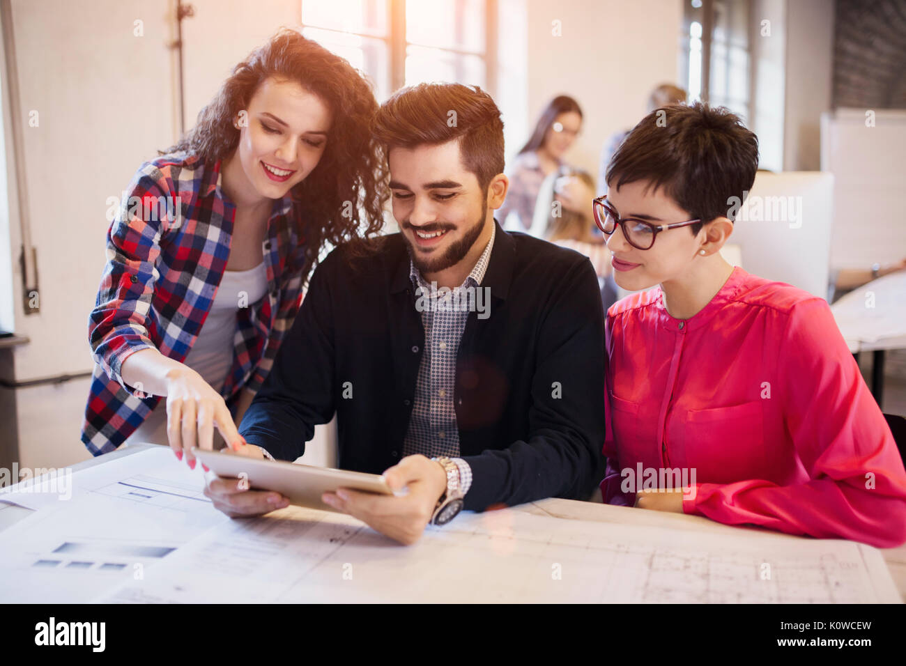 Group of young architects working on laptop Stock Photo - Alamy