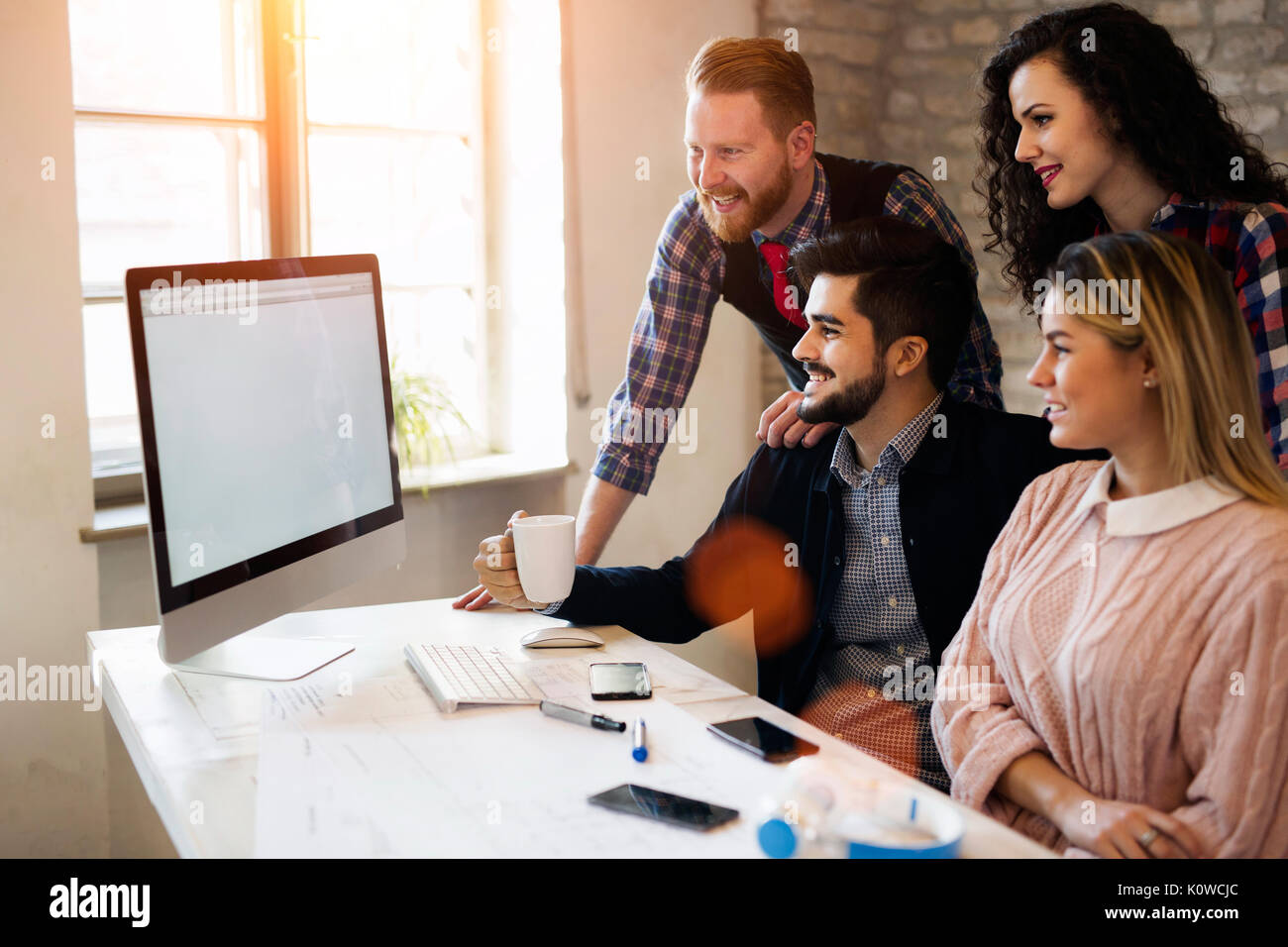Group of young architects working on computer Stock Photo - Alamy