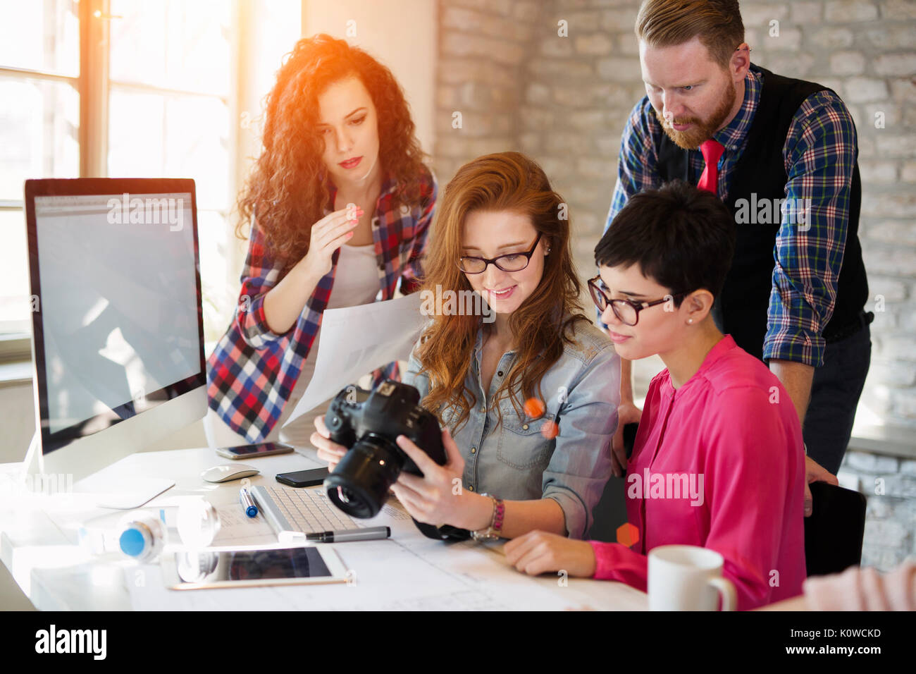 Group of young perspective designers working with camera Stock Photo ...
