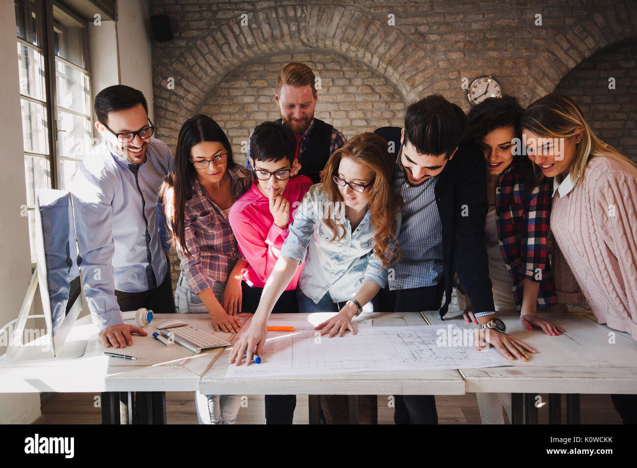 Portrait of young perspective designers having meeting Stock Photo - Alamy