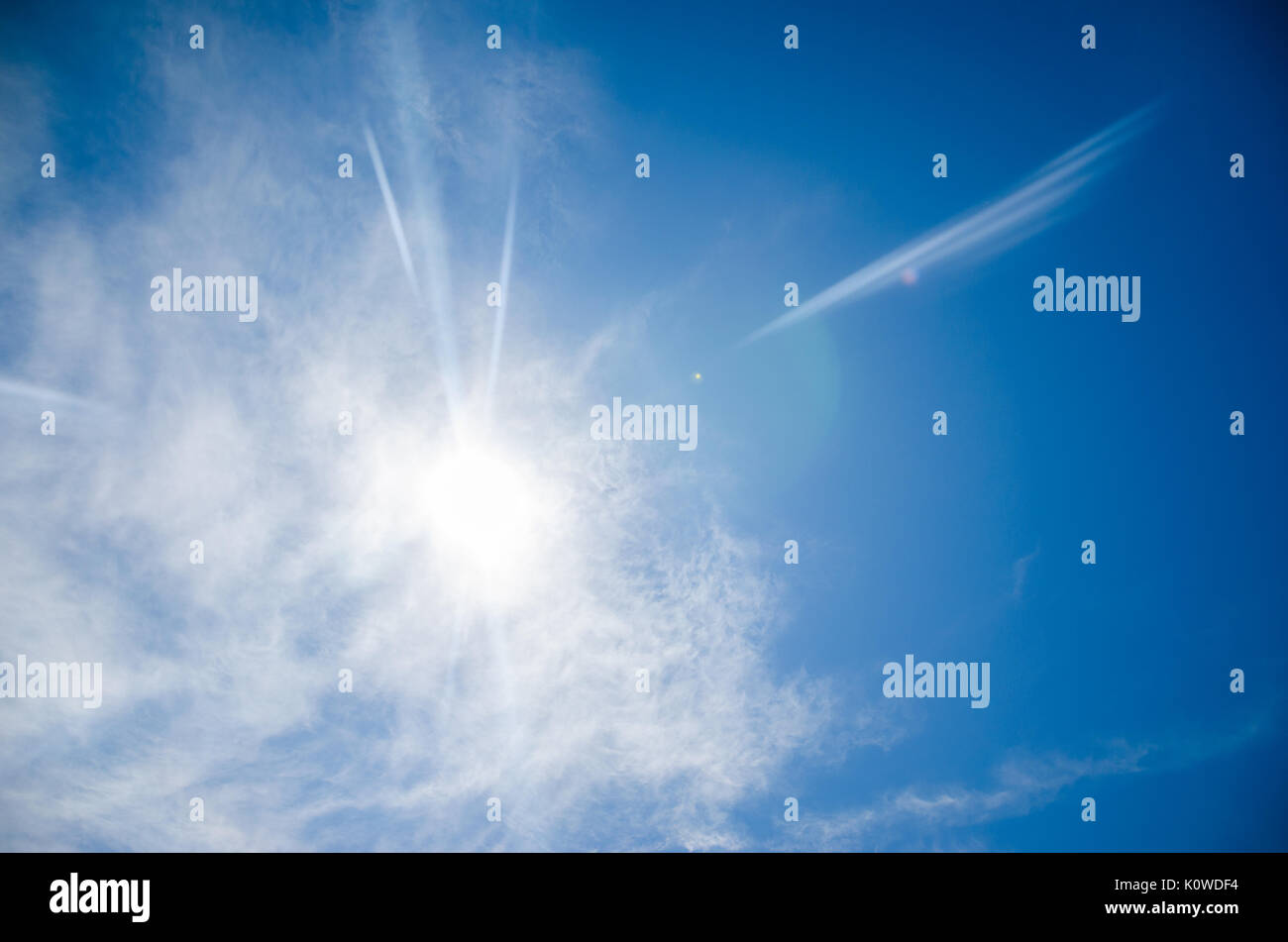 bright blue sky with the sun causing lens flare. Glare from the bright ...