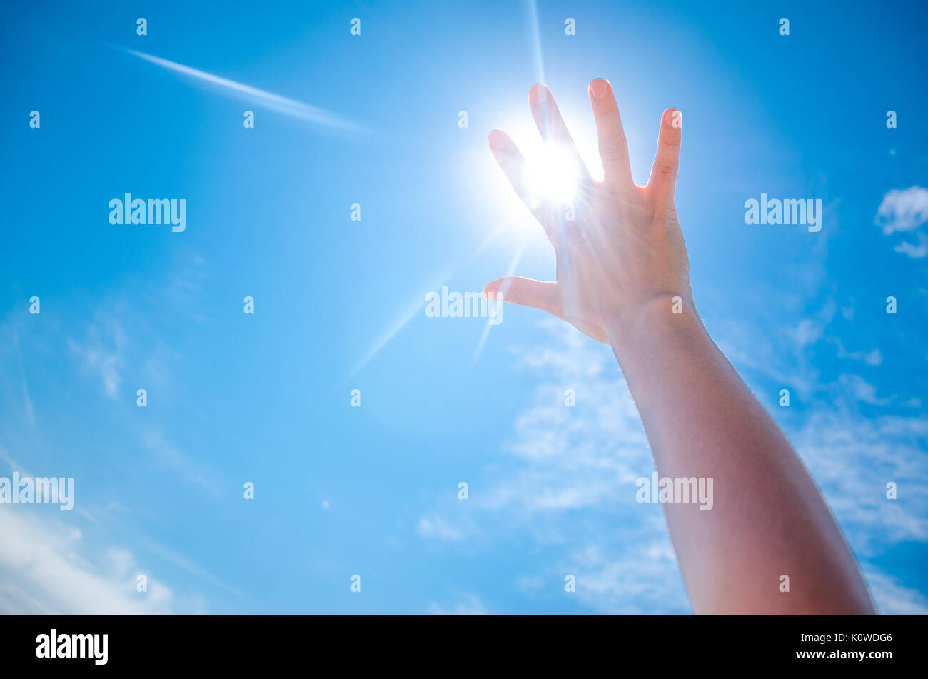 Silhouette of a Hand against a Sunset. Sun rays between fingers. Summer ...