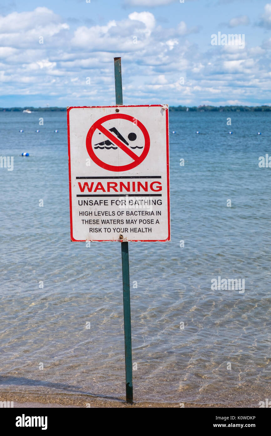 Posted sign warning swimmers of unsafe bacteria levels in the water at ...