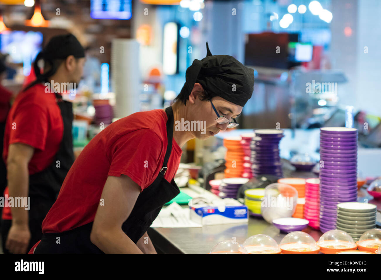 Busy production of sushi in Japanese restaurant Stock Photo - Alamy