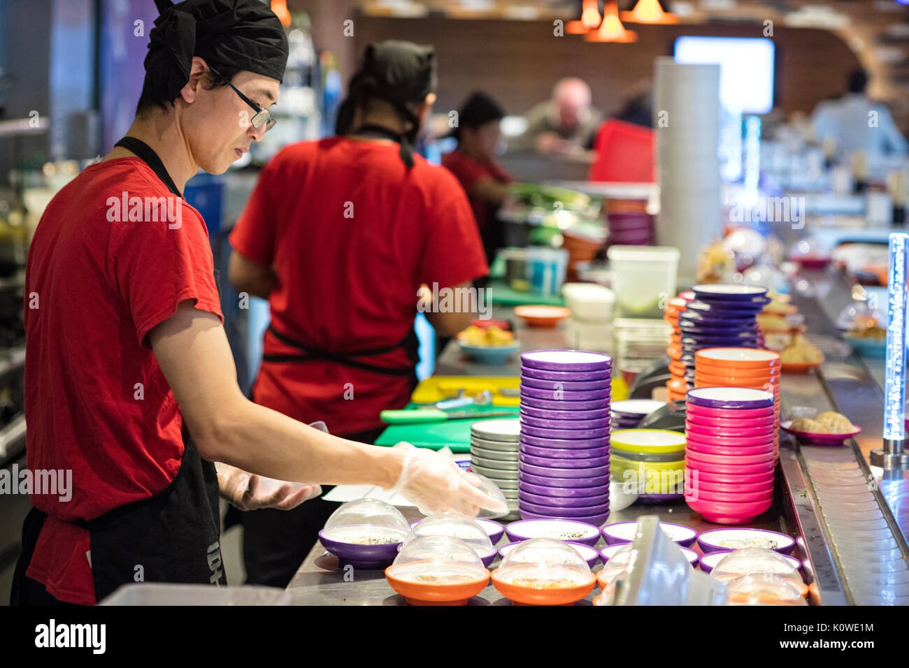 Busy production of sushi in Japanese restaurant Stock Photo - Alamy