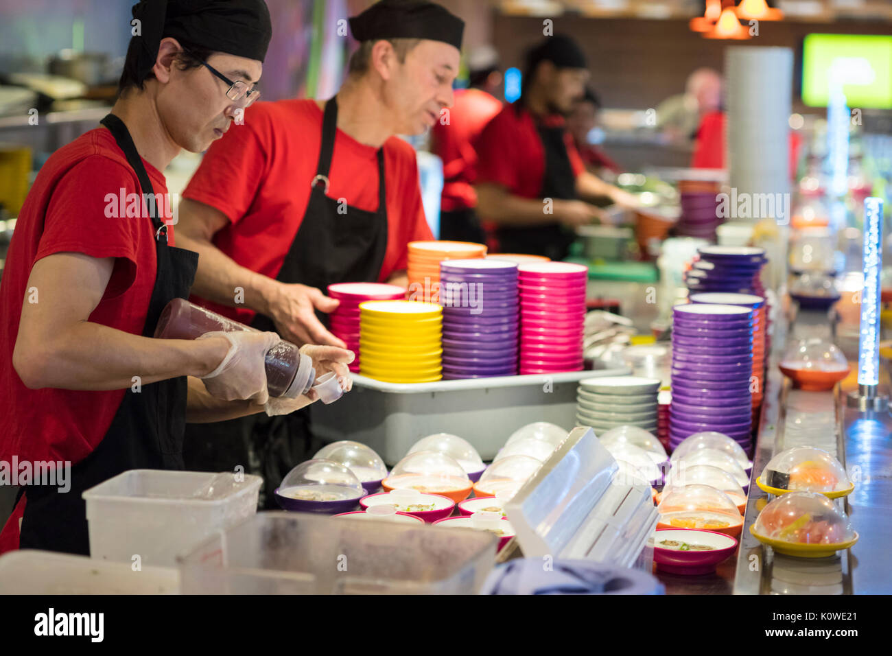 Busy production of sushi in Japanese restaurant Stock Photo - Alamy