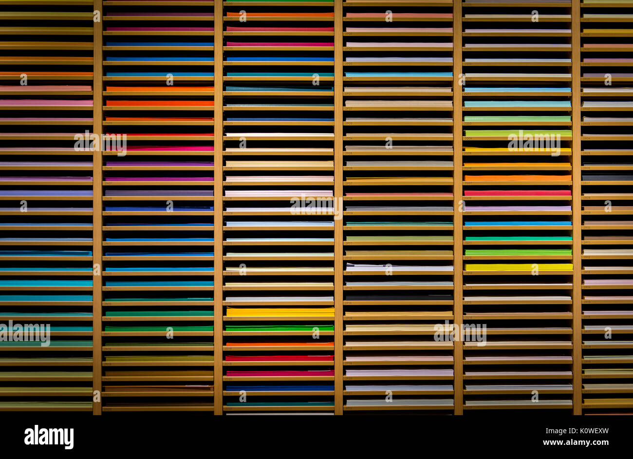 Stacks of color paper organized on shelves Stock Photo - Alamy