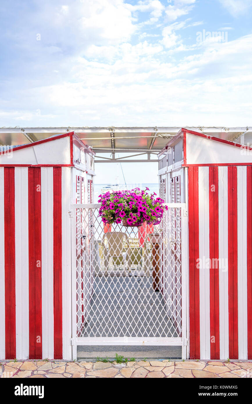 Red stripes changing Booths and purple flowers at the beach in Santa ...