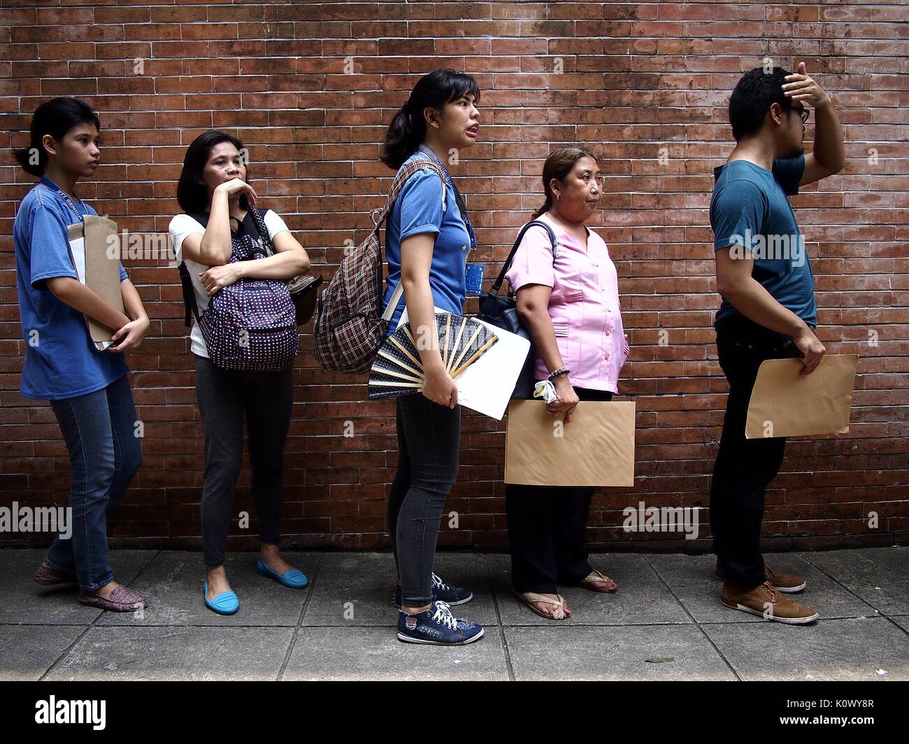 QUEZON CITY, PHILIPPINES - AUGUST 16, 2017: Students line up to submit ...