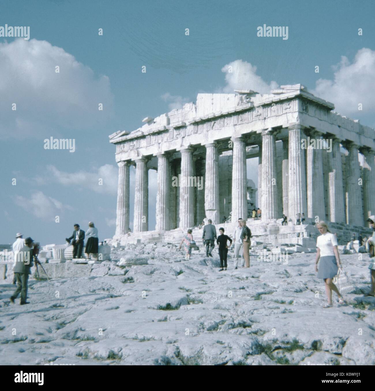 Tourists climbing on ruins and posing for photographs near the ...