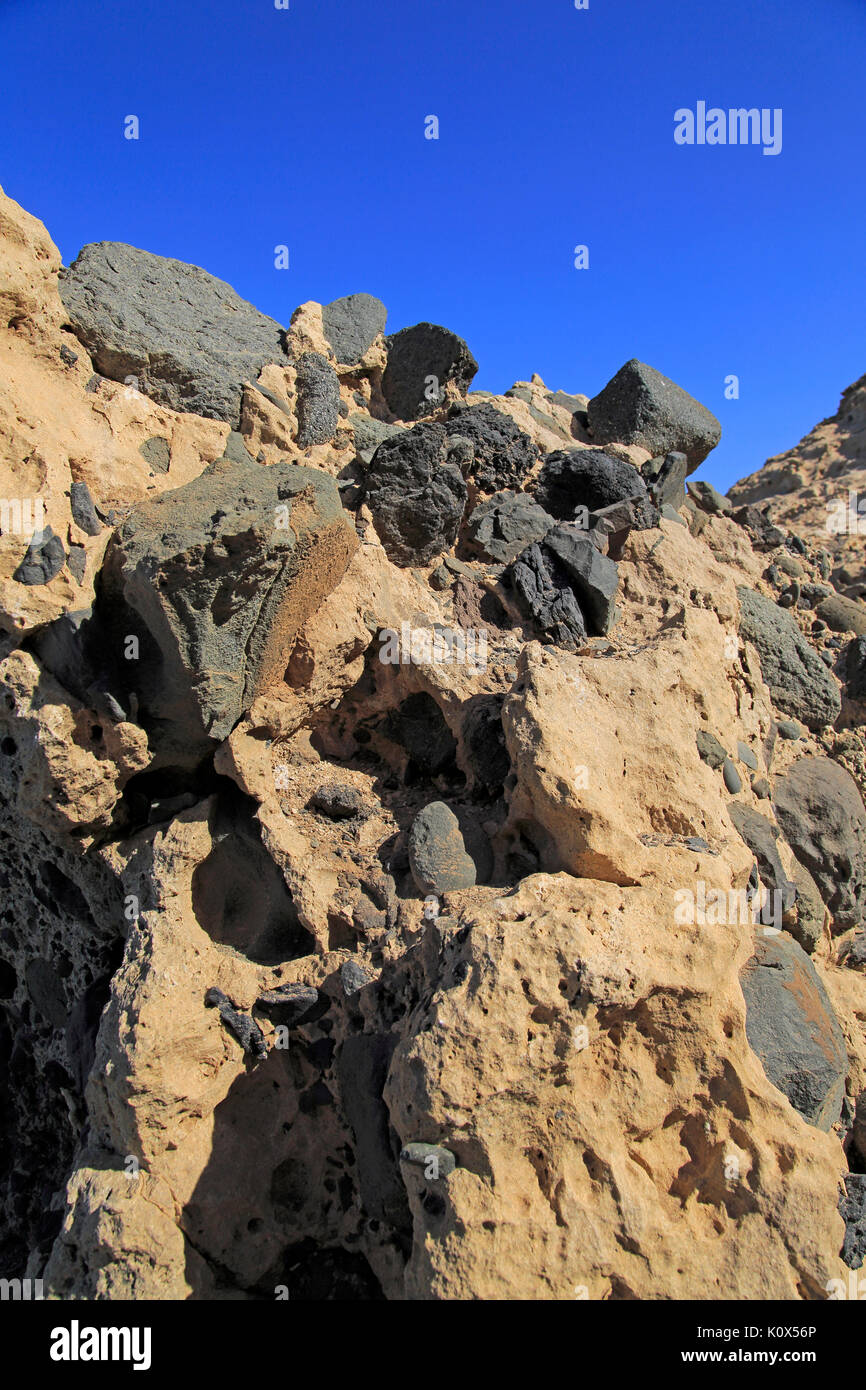 Conglomerate rock with volcanic bombs embedded in sediment, Playa de ...