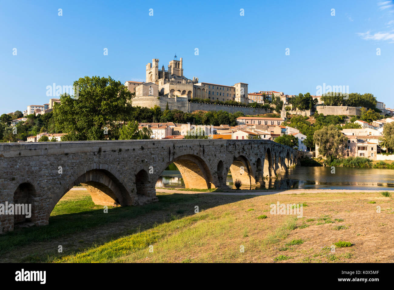 Views at sunset of the French city of Beziers, with trees and the old ...