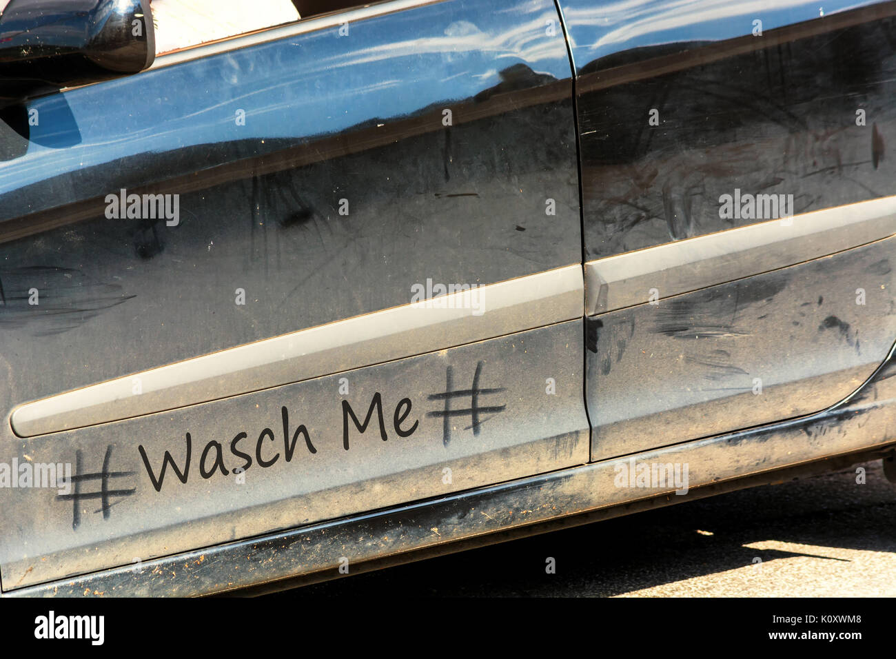 Lettering in English "Wash Me" Side view of a filthy car. Concept ...