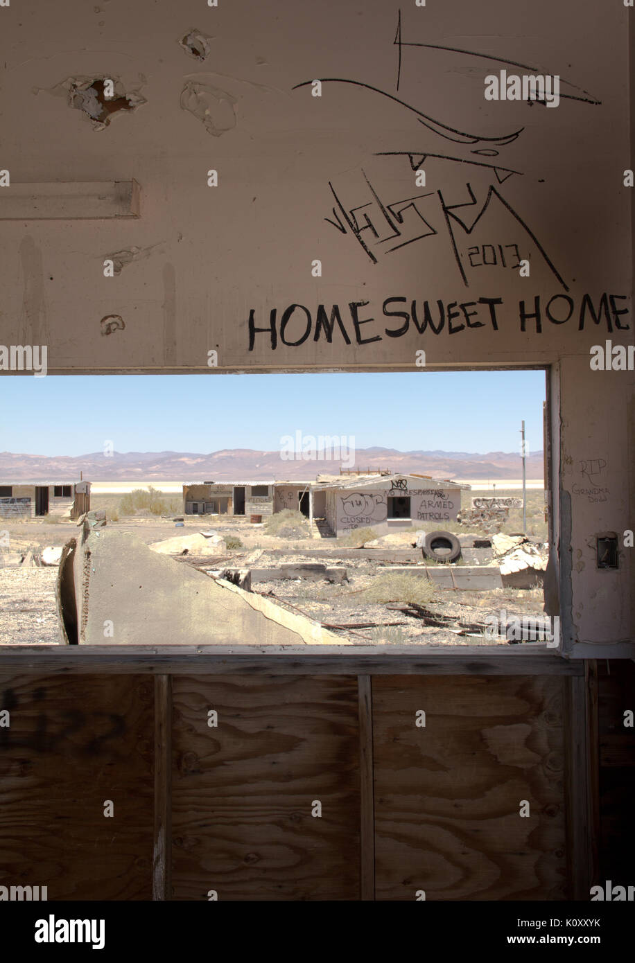 A window overlooking an abandoned Motel covered with graffiti in the ...