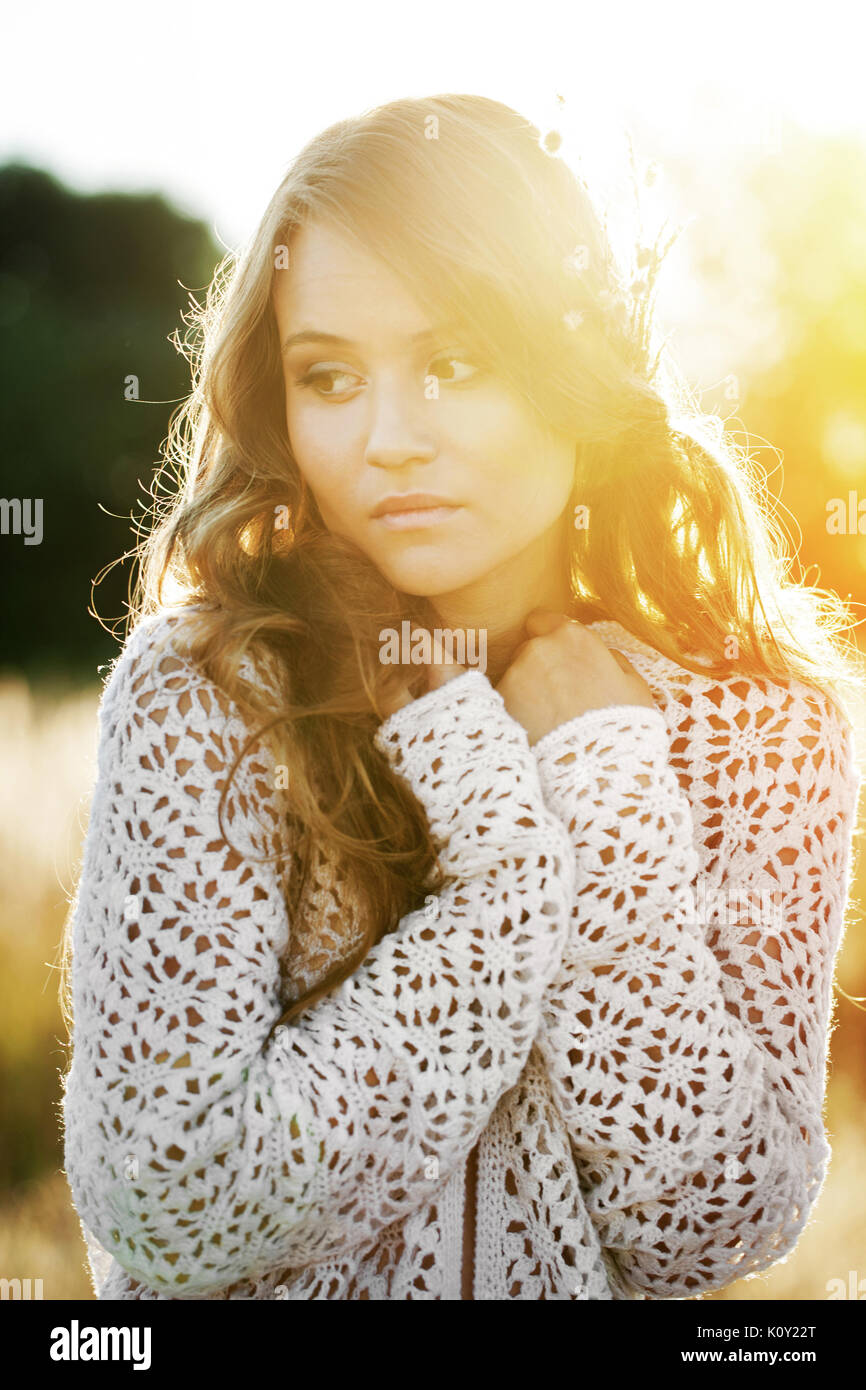 Beautiful lady model posing in an open field at golden hour Stock Photo ...