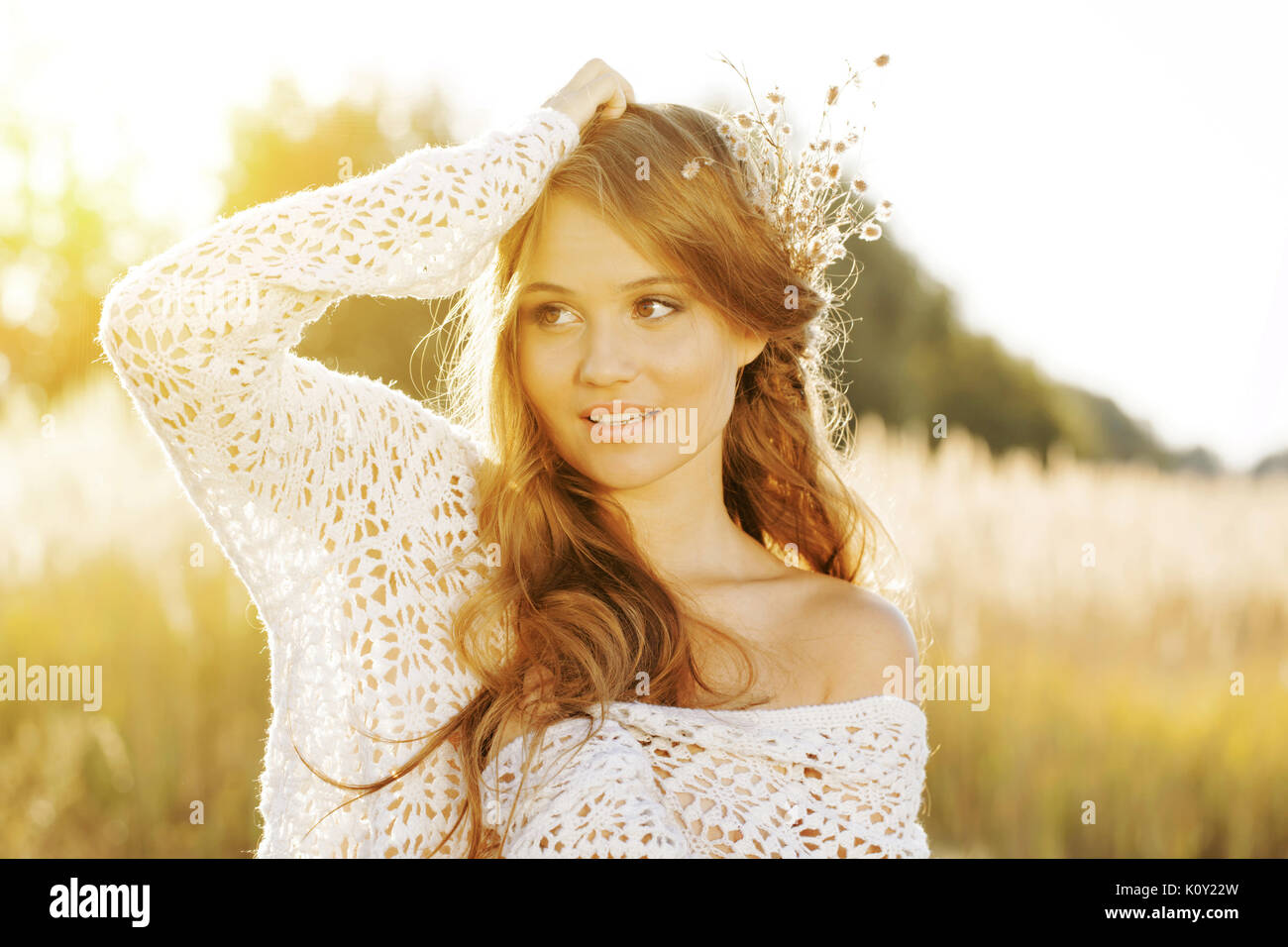 Beautiful lady model posing in an open field at golden hour Stock Photo ...