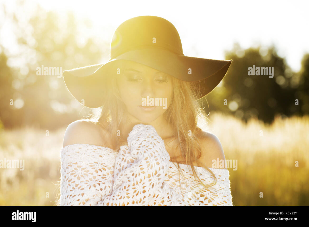 Beautiful lady model posing in an open field at golden hour - outdoors ...