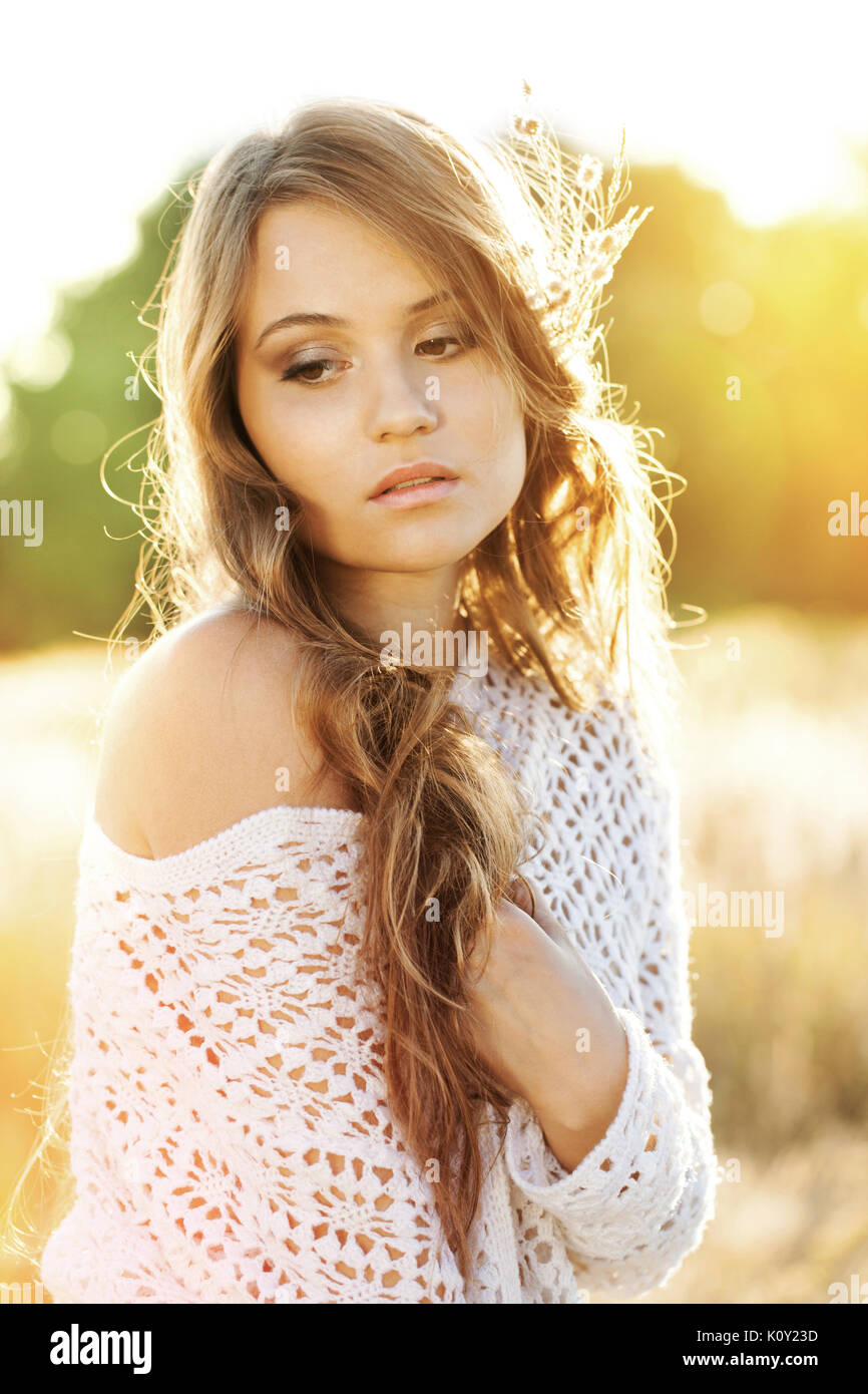 Beautiful model in an open field at golden hour Stock Photo - Alamy