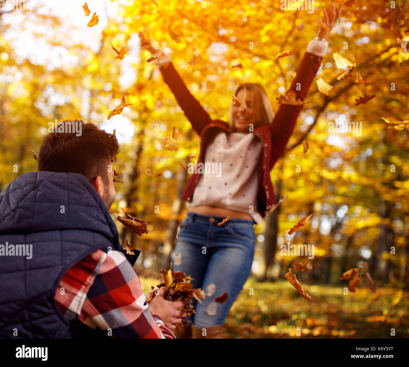 Young couple throwing fall leaves Stock Photo - Alamy