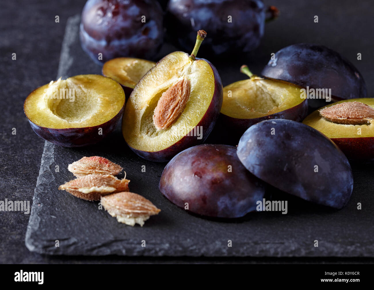 Freshly picked plums on dark table background Stock Photo - Alamy
