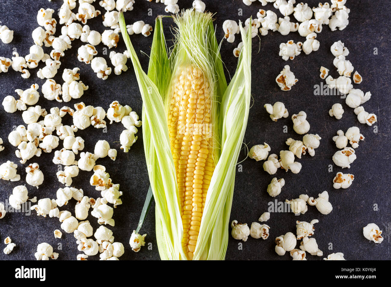 fresh corn and popcorn on black table background Stock Photo - Alamy