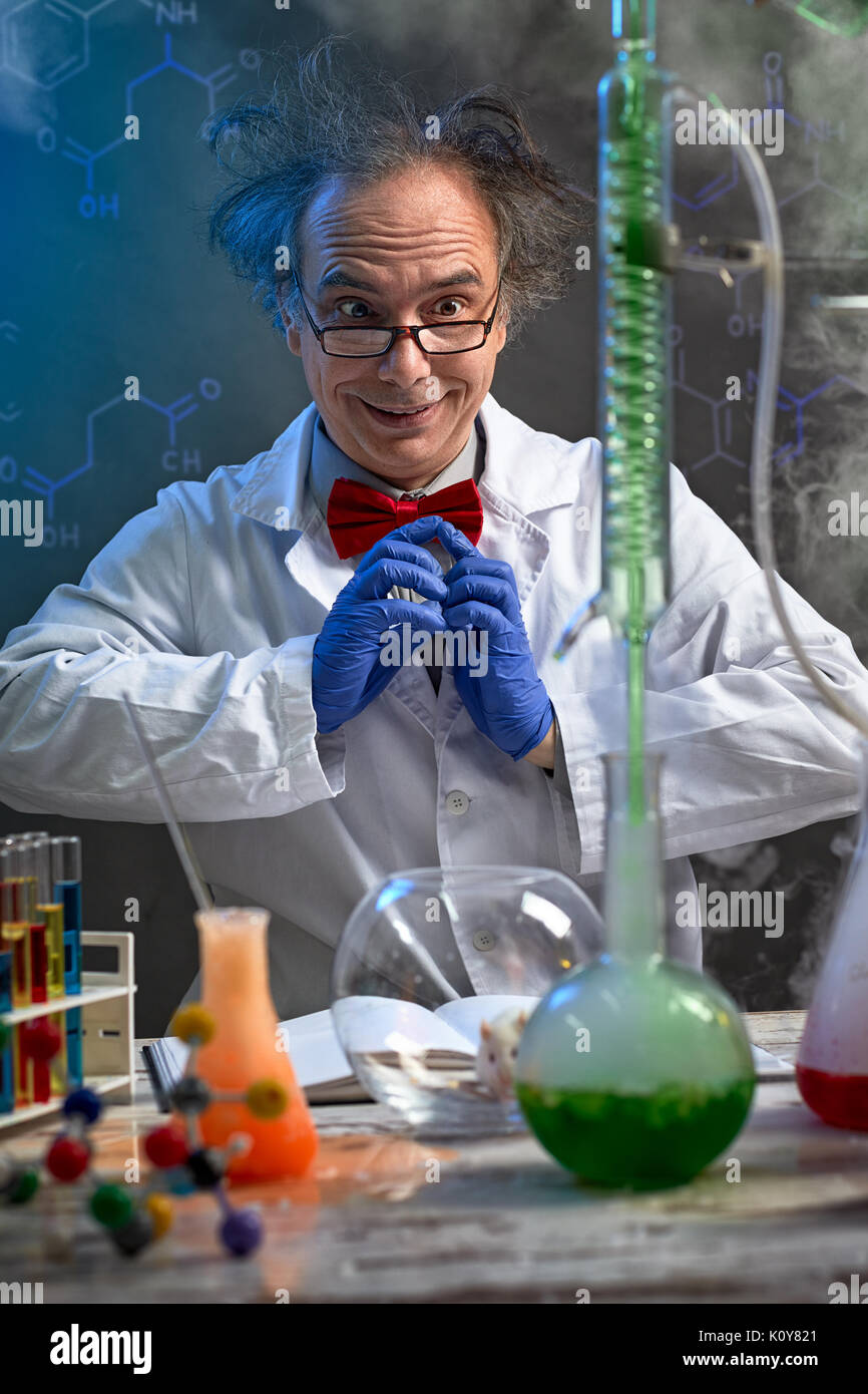 Happy crazy chemist looking in experiment that happens Stock Photo - Alamy