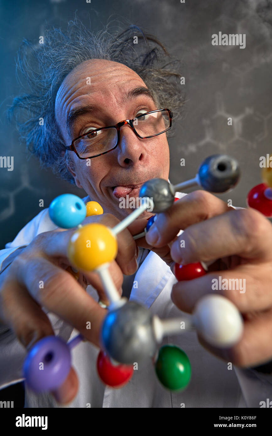 Crazy scientist building molecular atom model Stock Photo - Alamy