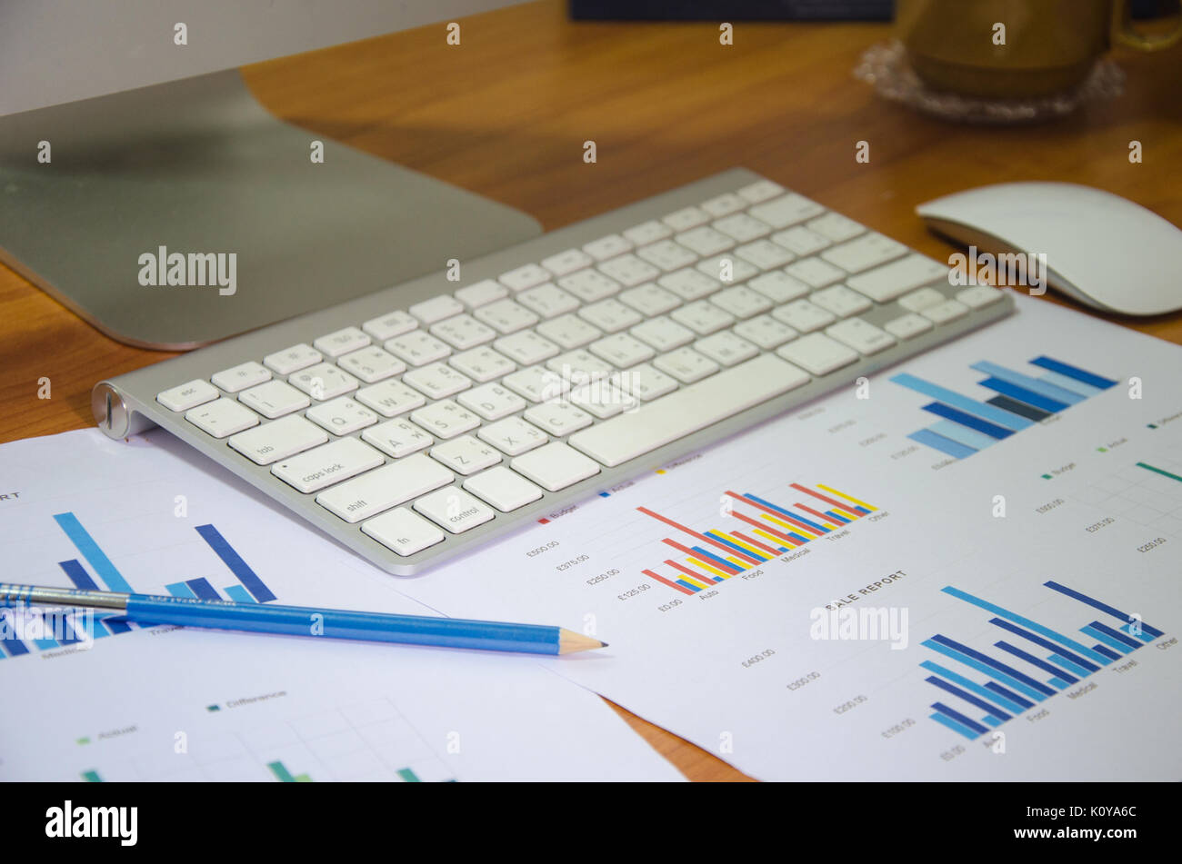 Business workplace with keyboard mouse and papers with graphs and ...
