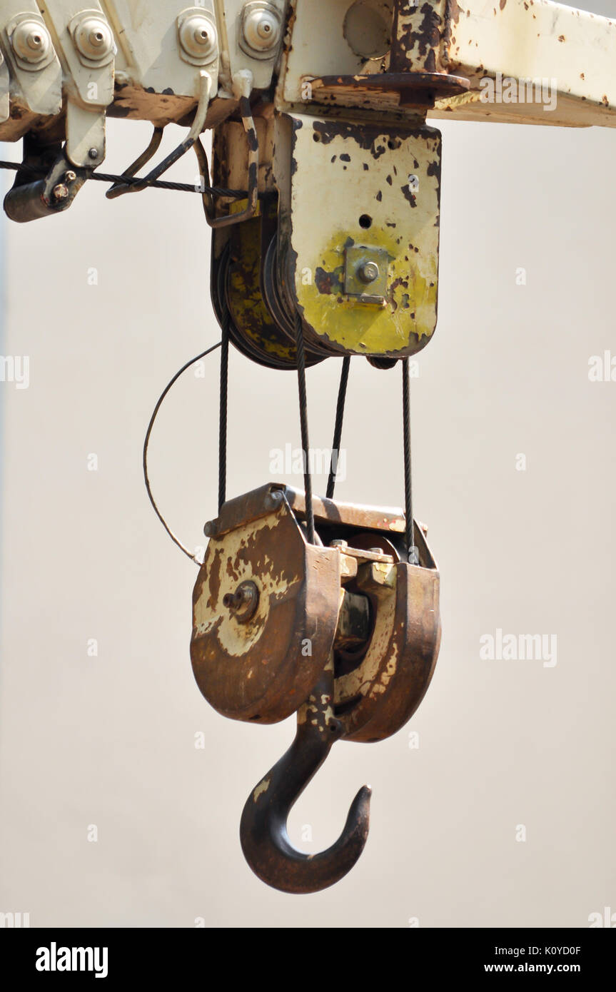 Lifting hook attached to sheave suspended by wire rope from boom of ...