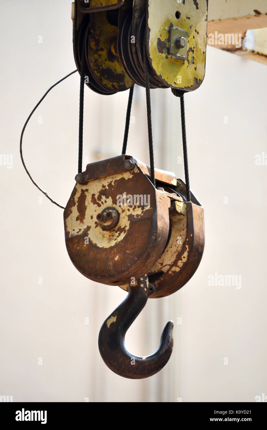 Lifting hook attached to sheave suspended by wire rope from boom of ...