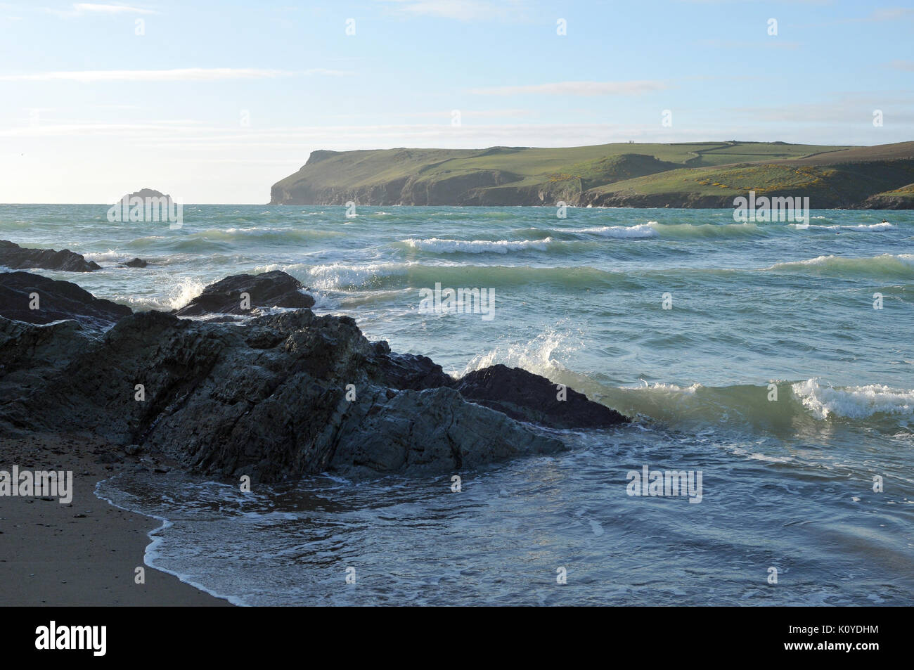 waves and surf crashing against the rocks on the sandy surfers beach of ...