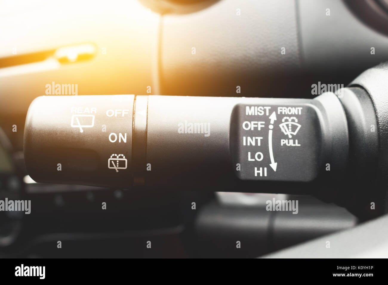 Closeup shot of male driver adjusting speed of screen wipers in car ...
