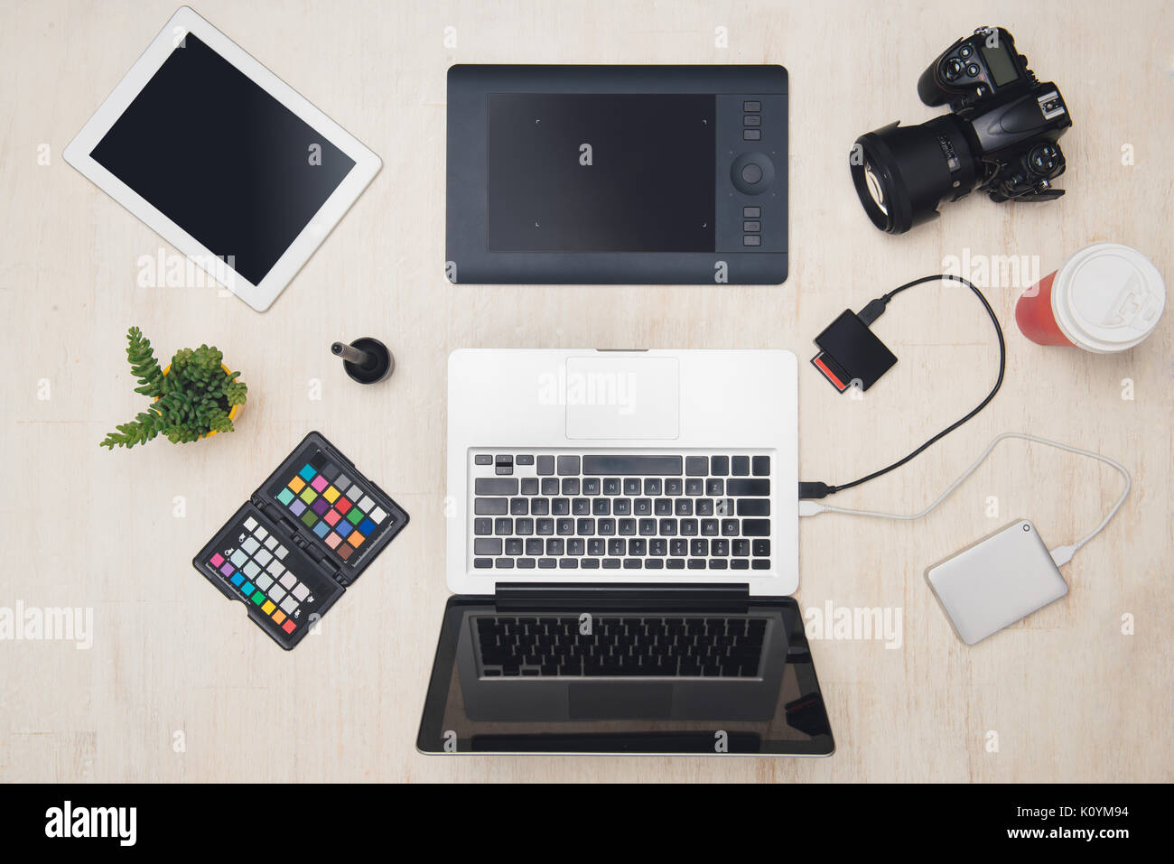 Photo processing on laptop with isolated display for mock up. Camera ...