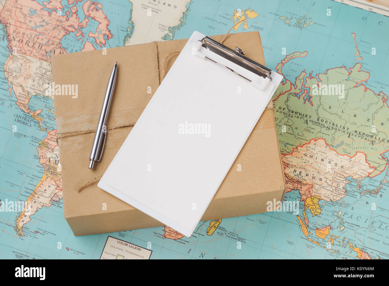 International shipping. Cardboard box on the geographical map ...