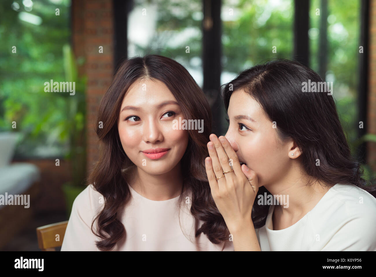 Telling secrets hi-res stock photography and images - Alamy