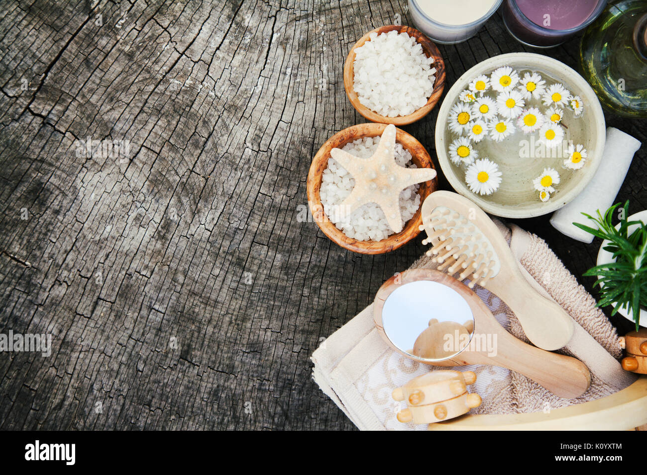 Spa and wellness setting with flowers, floral water and towel. Natural ...